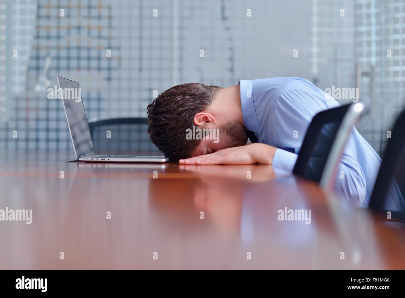 Young business man with problems and stress in the office Stock Photo ...
