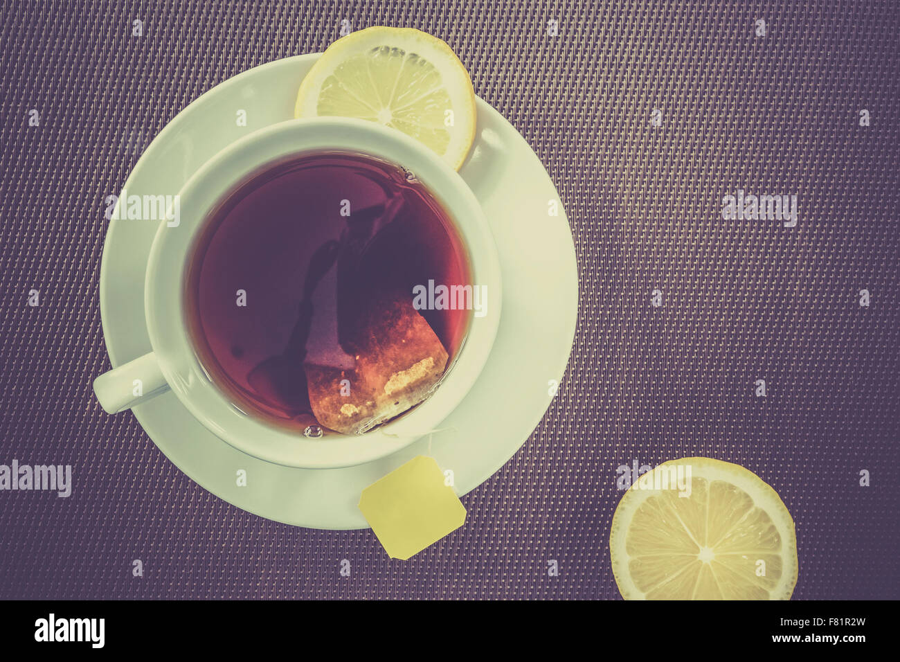 Aerial view of tea cup and slice of lemon on brown background Stock ...