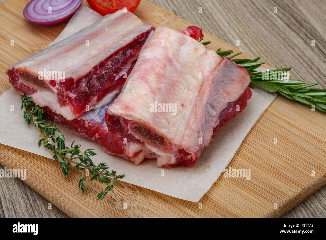 Raw beef ribs with rosemary and thyme - ready for cooking Stock Photo - Alamy
