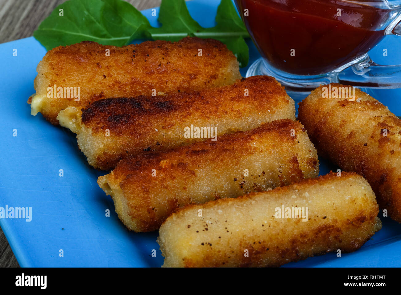 Fry cheese sticks with herbs and tomato sauce Stock Photo - Alamy