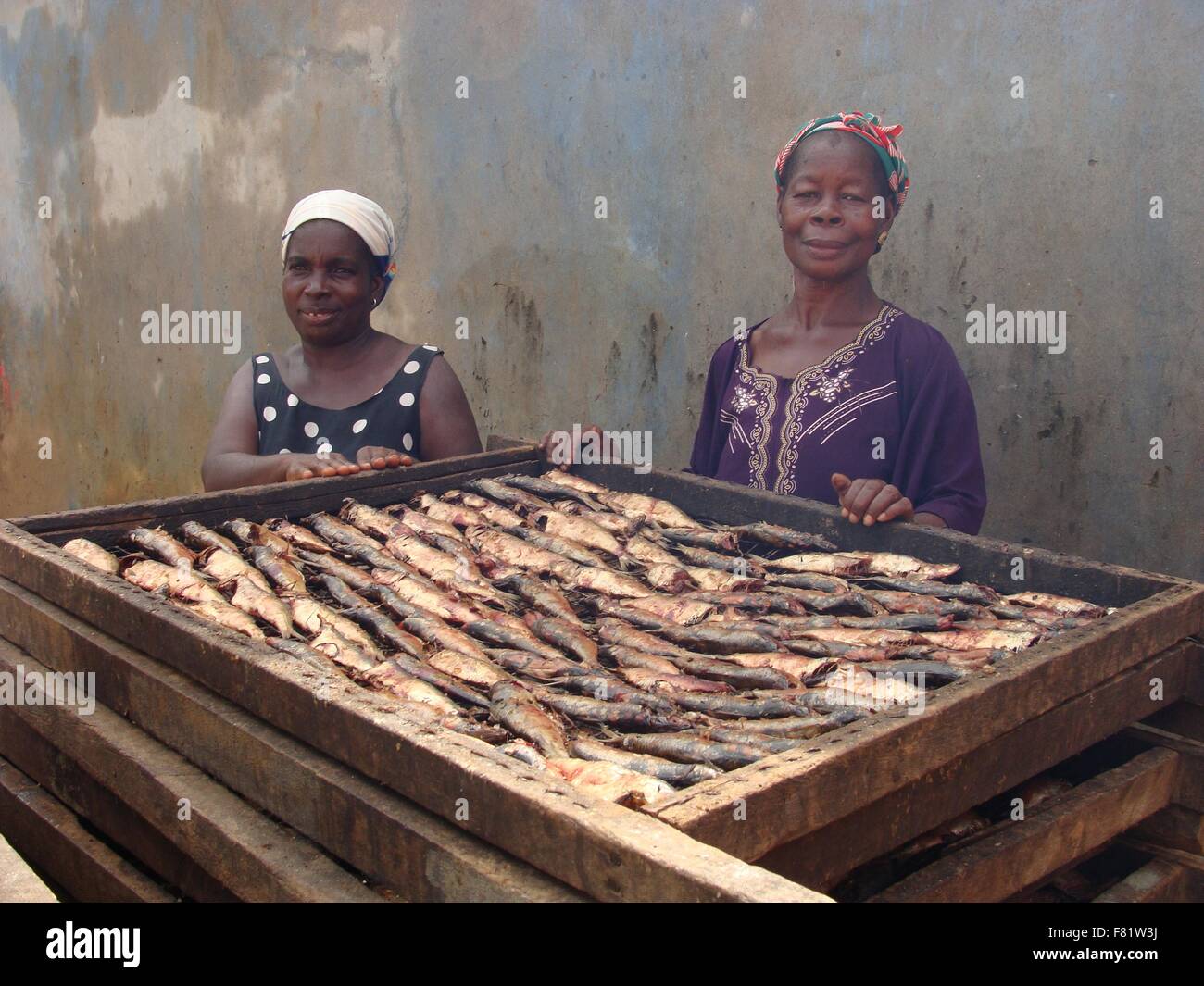 Women use a Chorker oven to smoke sardinella fish in Takoradi, Ghana ...