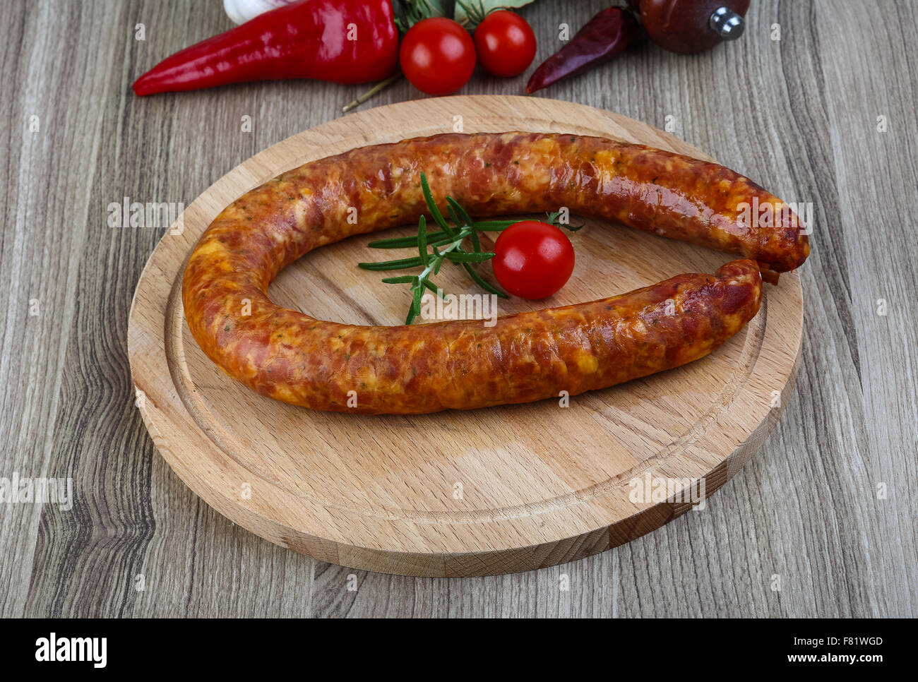 Sausage ring with rosemary and pepper on the wood background Stock ...
