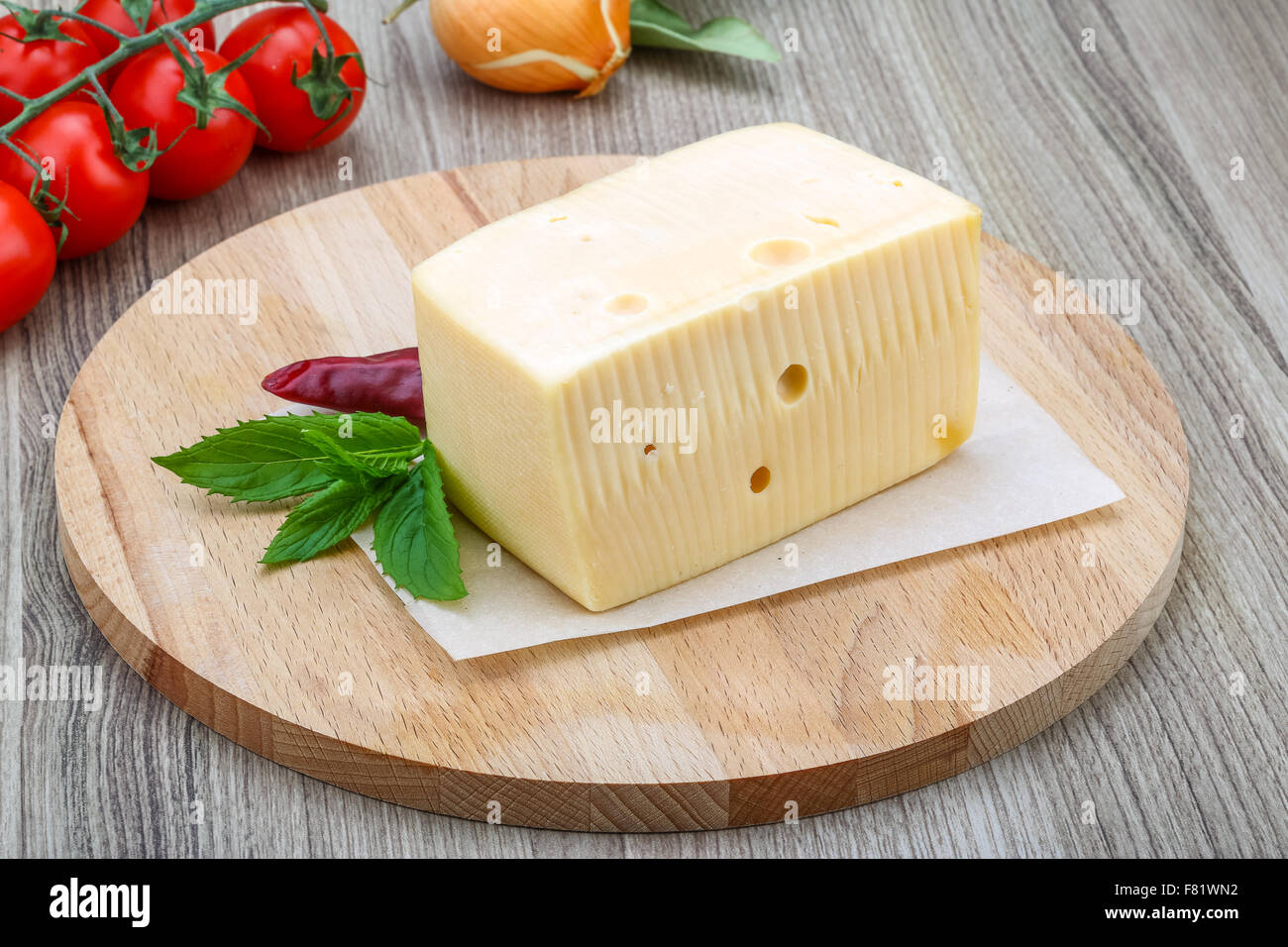 Yellow cheese brick with mint leaves on the wood background Stock Photo ...