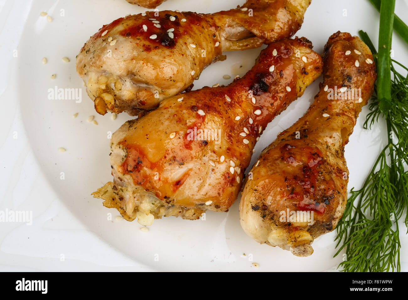 Grilled chicken legs with sesame seeds, dill and green onion Stock ...