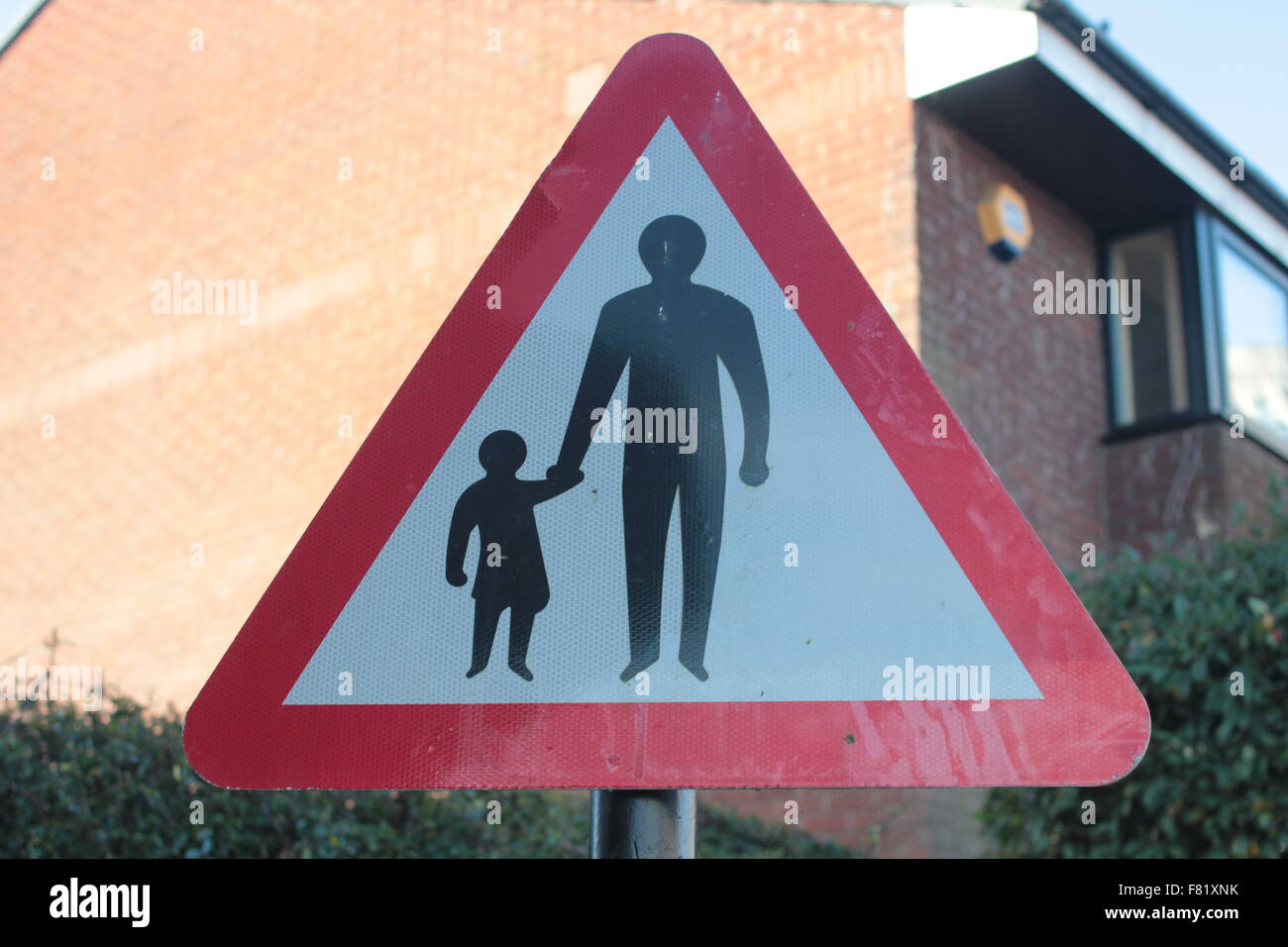 Red triangle road sign parent and child Stock Photo - Alamy