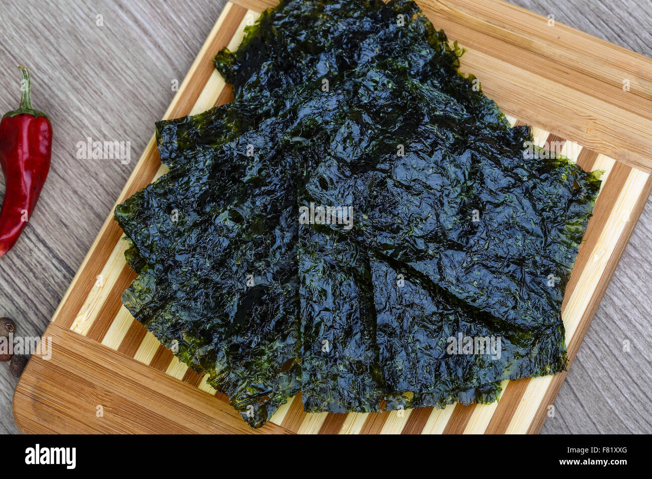 Korean traditional snack - Nori seaweed sheets on the wood background ...