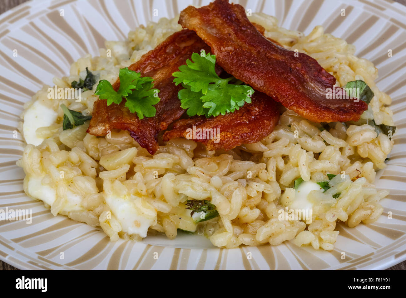 Risotto with mozzarella, basil leaves and bacon Stock Photo - Alamy