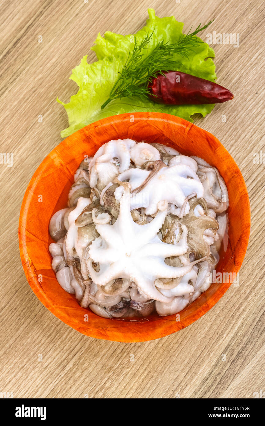 Raw baby octopus in the bowl ready for cooking Stock Photo - Alamy