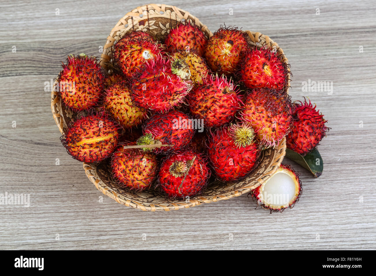 Asian fruit - rambutan - on the wood background Stock Photo - Alamy