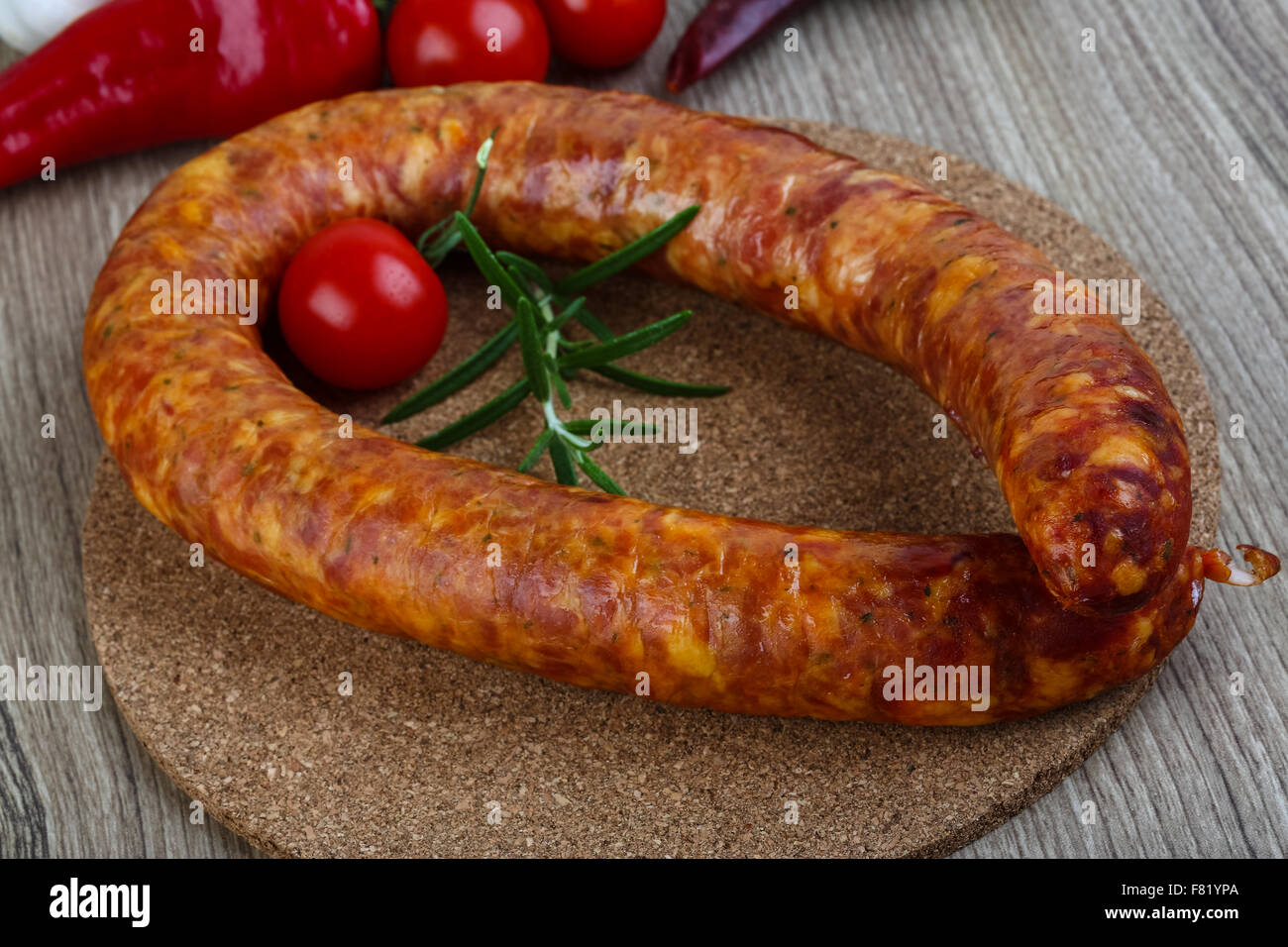 Sausage ring with rosemary and pepper on the wood background Stock ...