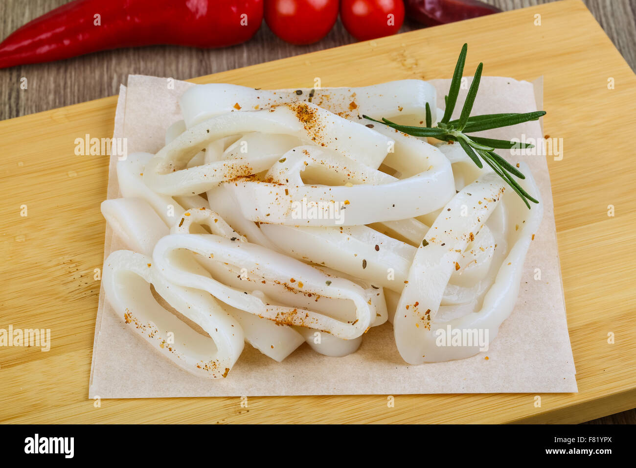 Raw squid rings with rosemary and spices - ready for cooking Stock ...