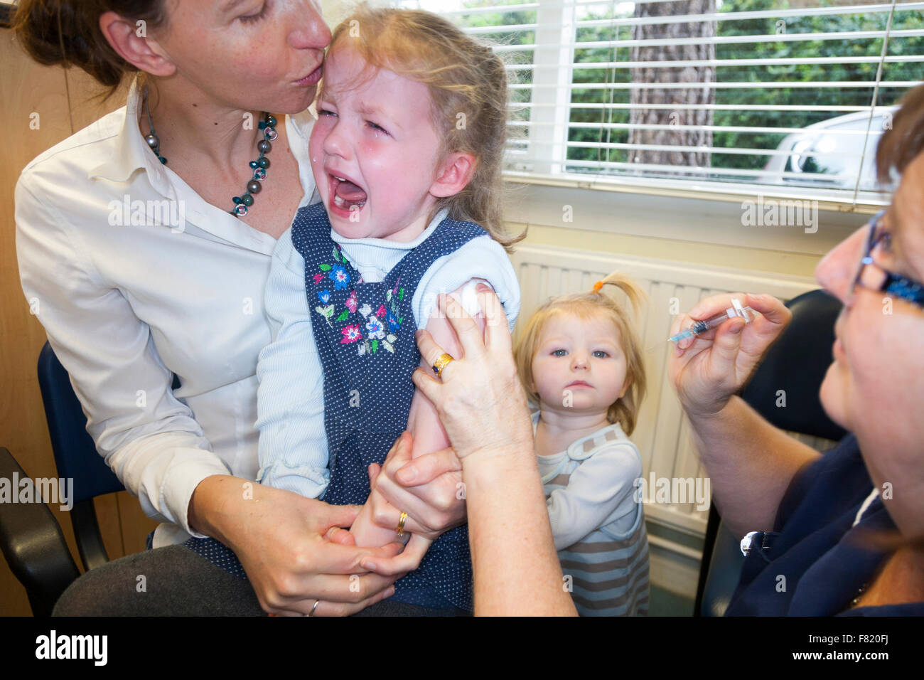 Nurse giving NHS 4-in-1 pre-school booster & MMR second dose ...