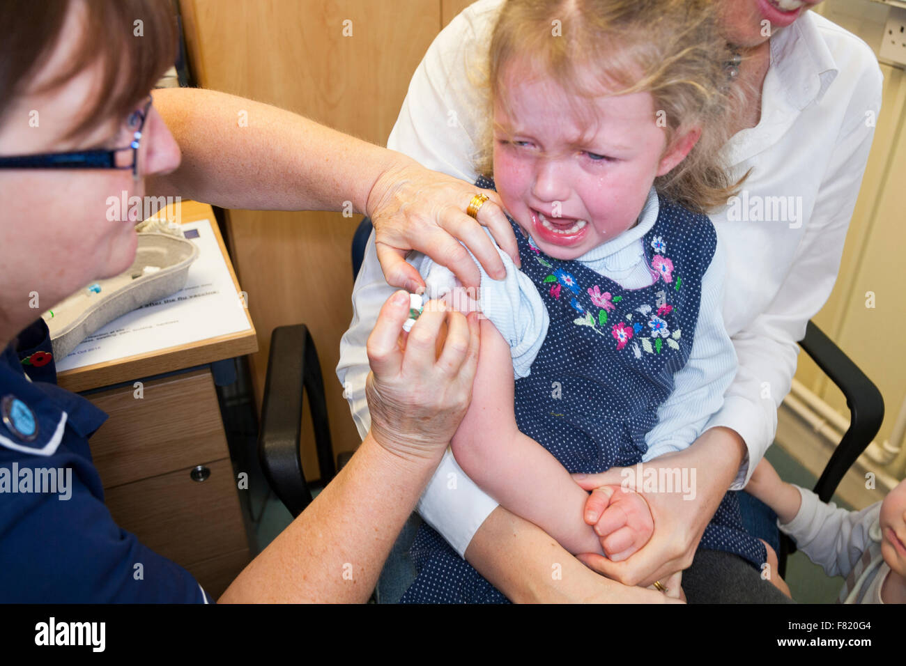 Nurse giving NHS 4-in-1 pre-school booster & MMR second dose ...
