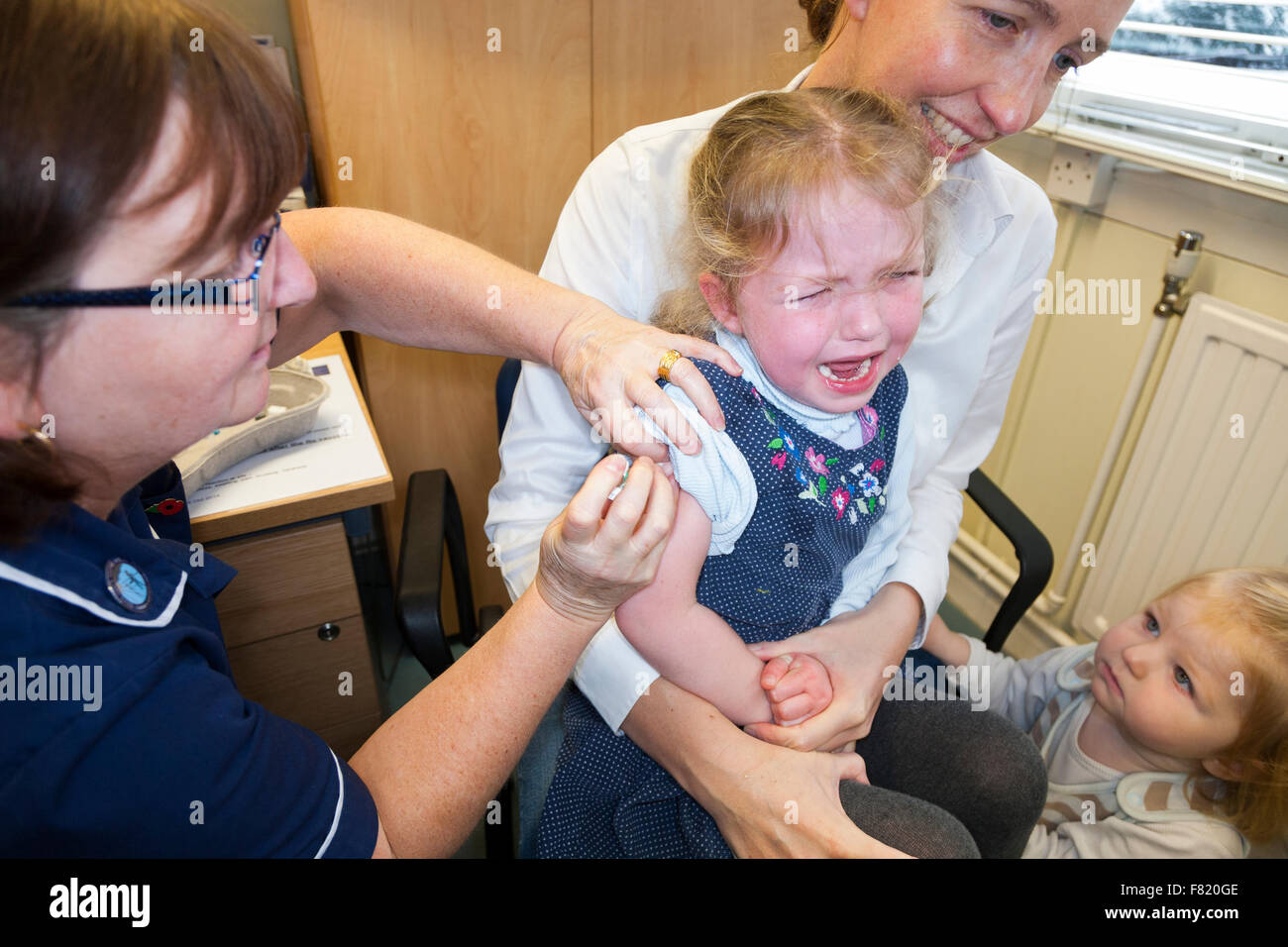 Nurse giving NHS 4-in-1 pre-school booster & MMR second dose ...