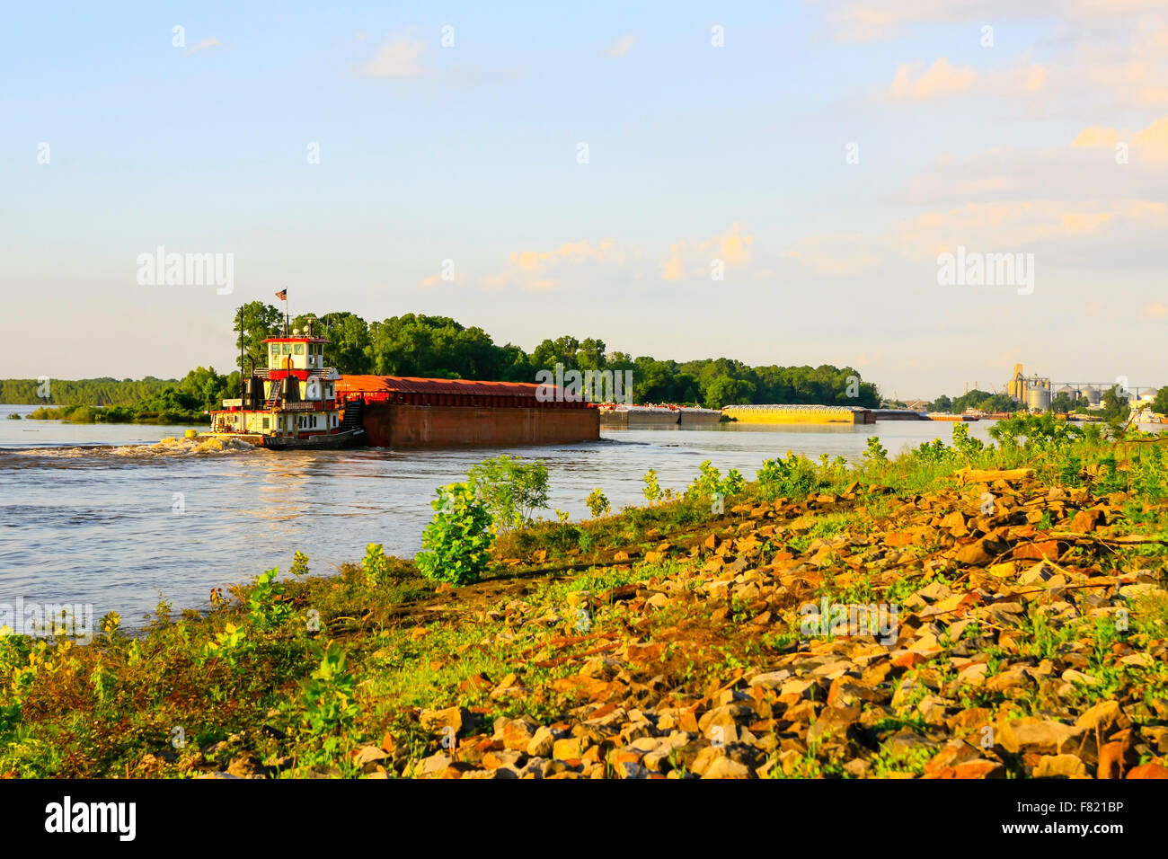 Tugboat pushing barges along the great Mississippi river seen here at ...