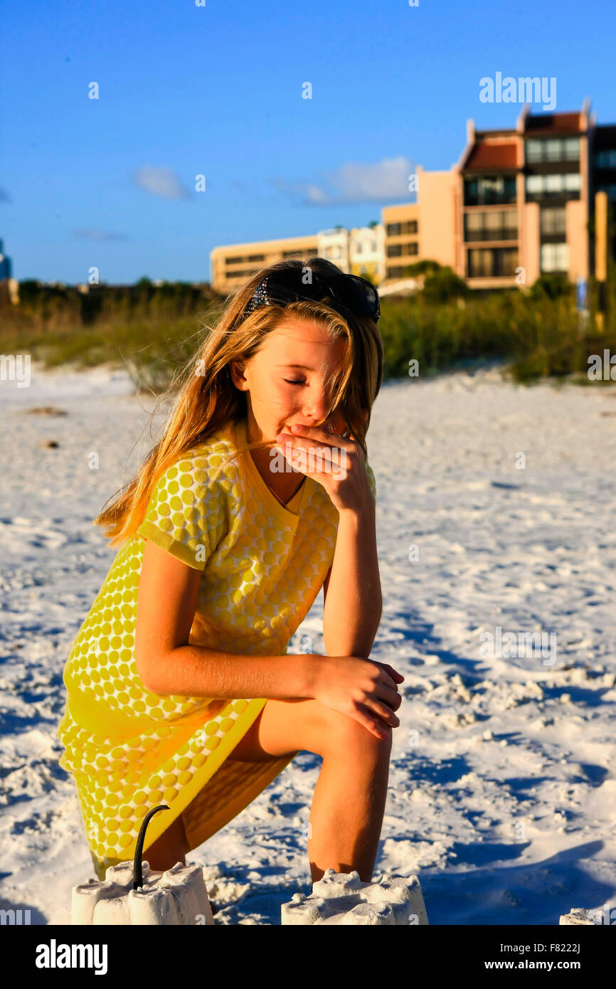 Young Girl Posing At Sunset By The Sand Castle She Built On Siesta Key