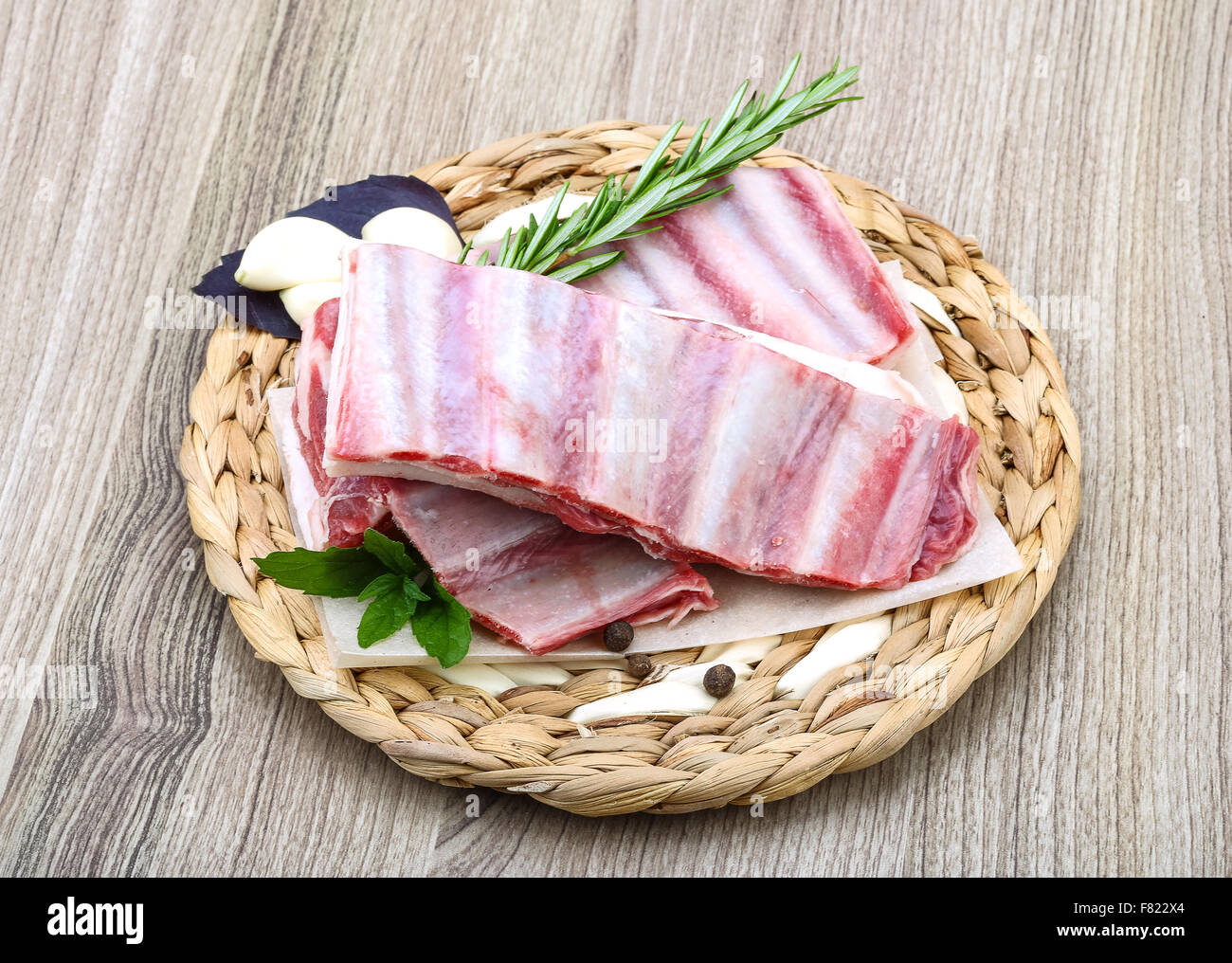 Fresh cold Raw lamb ribs with garlik and pepper - ready for cooking ...