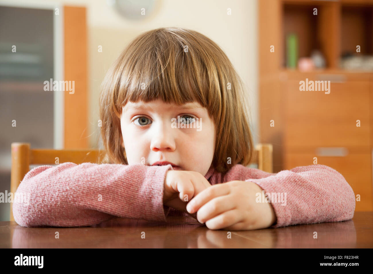 calm two-year child at table in home interior Stock Photo - Alamy