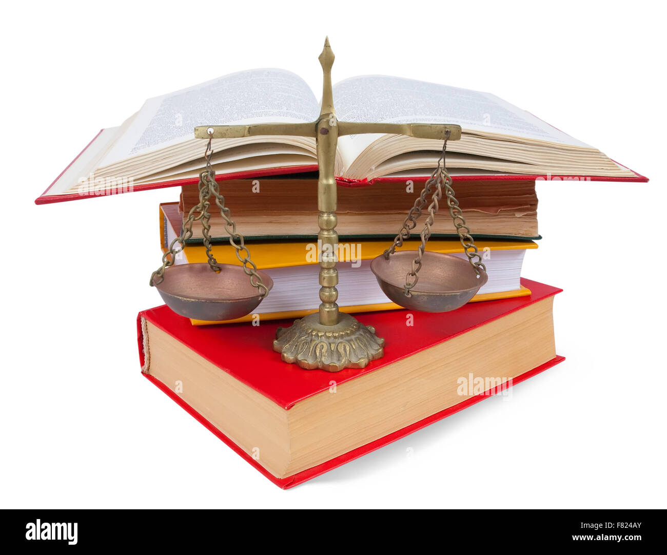 Scales of justice atop legal books. Isolated with clipping path over ...