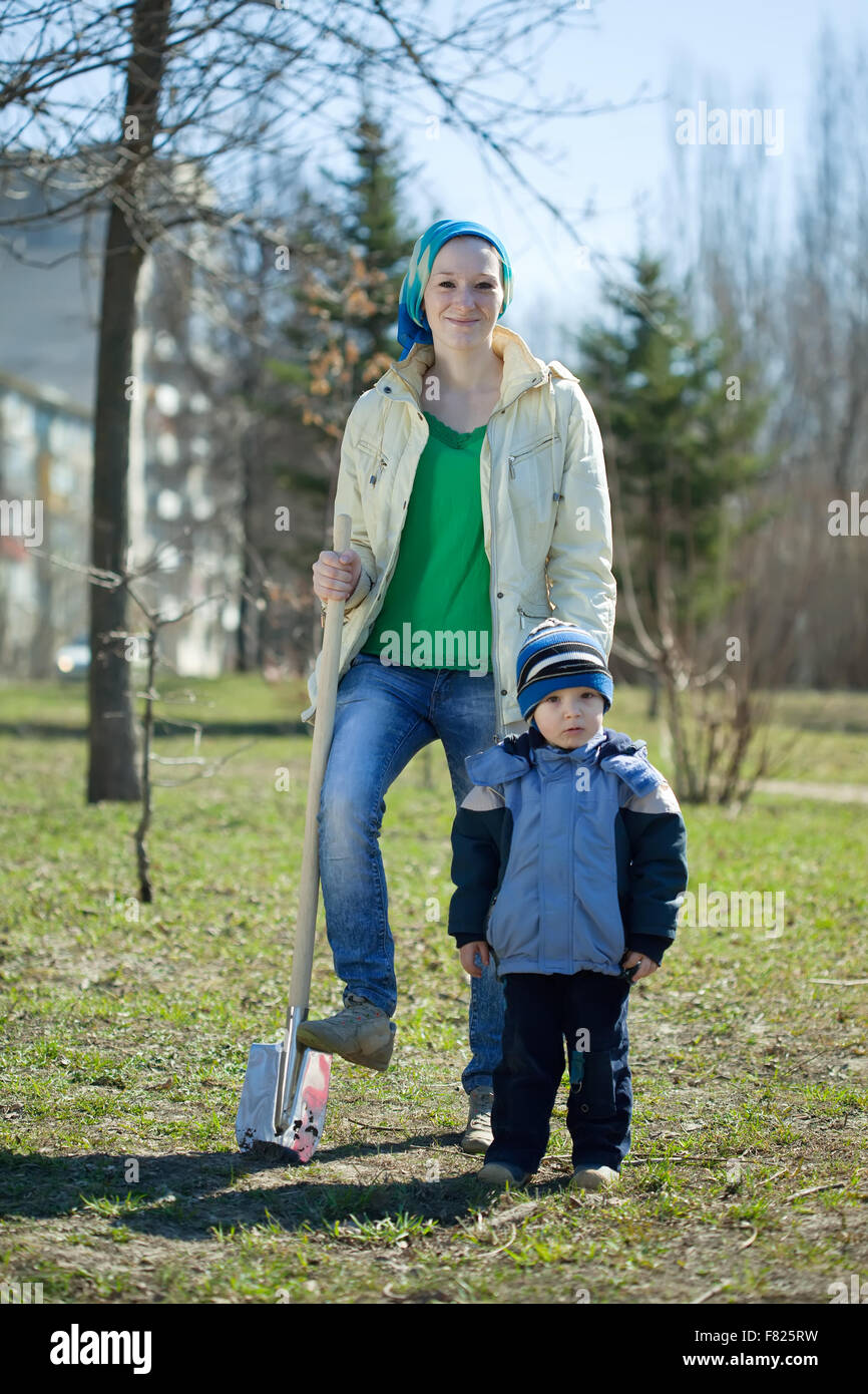young woman and boy working with spade in city park Stock Photo - Alamy