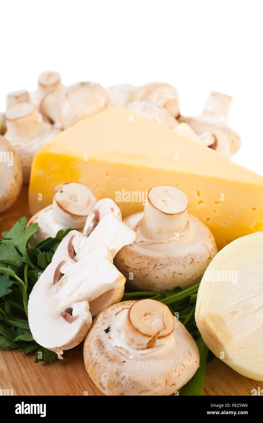 Closeup of champignon mushroom with cheese on cutting board over white ...