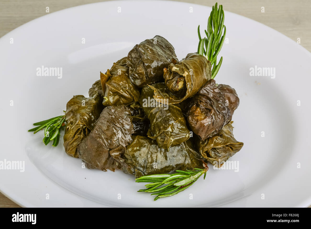 Greek dolma in grape leaves with meat served rosemary Stock Photo - Alamy