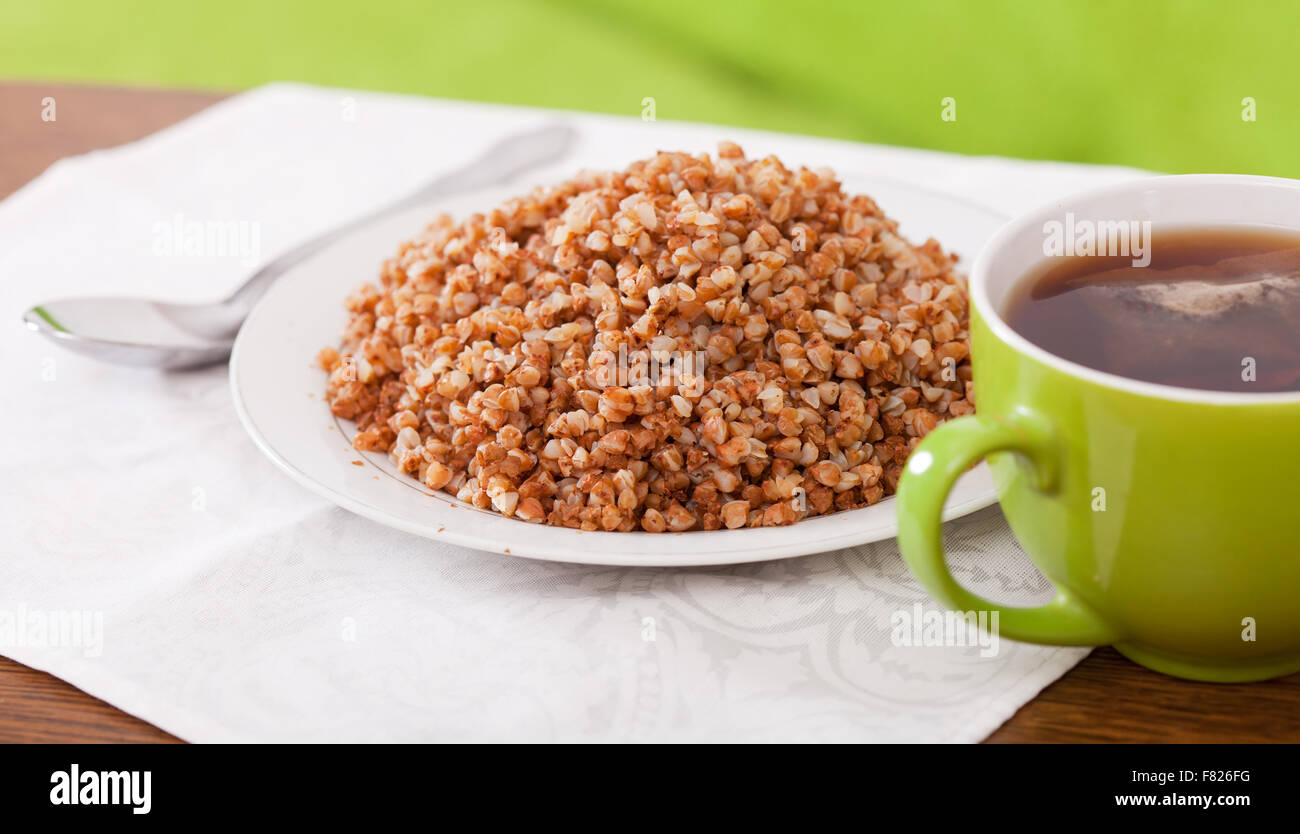buckwheat porridge in plate with tea Stock Photo - Alamy