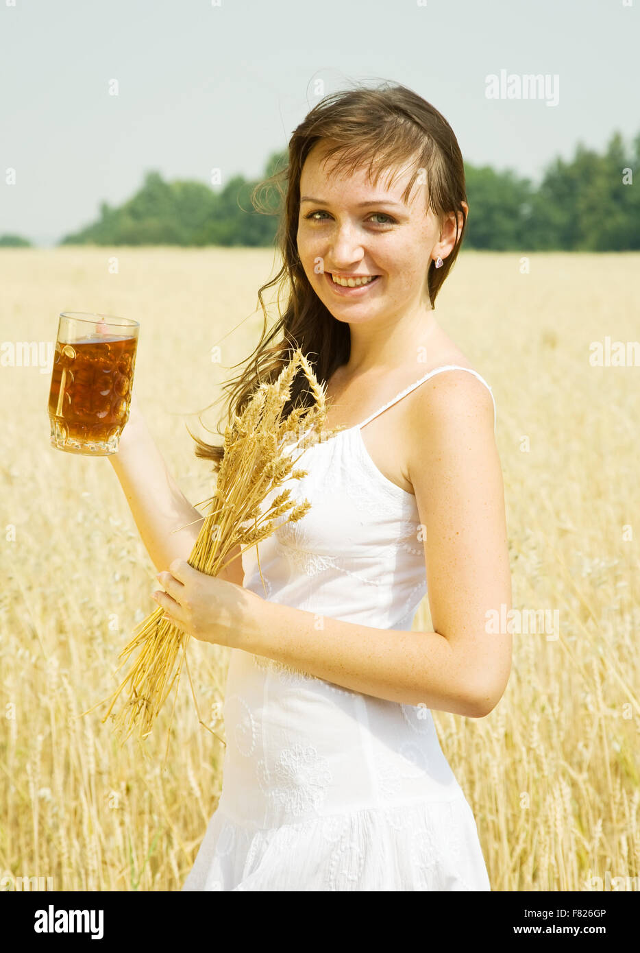 Girl with beer at cereals field in summer Stock Photo - Alamy
