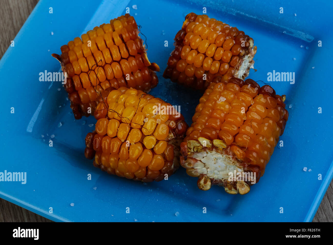 Grilled salted corn on the wood background Stock Photo - Alamy
