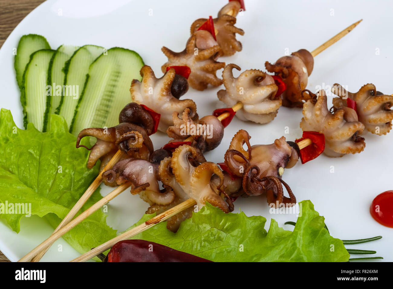 Barbecue baby octopus with bell pepper and spices Stock Photo - Alamy