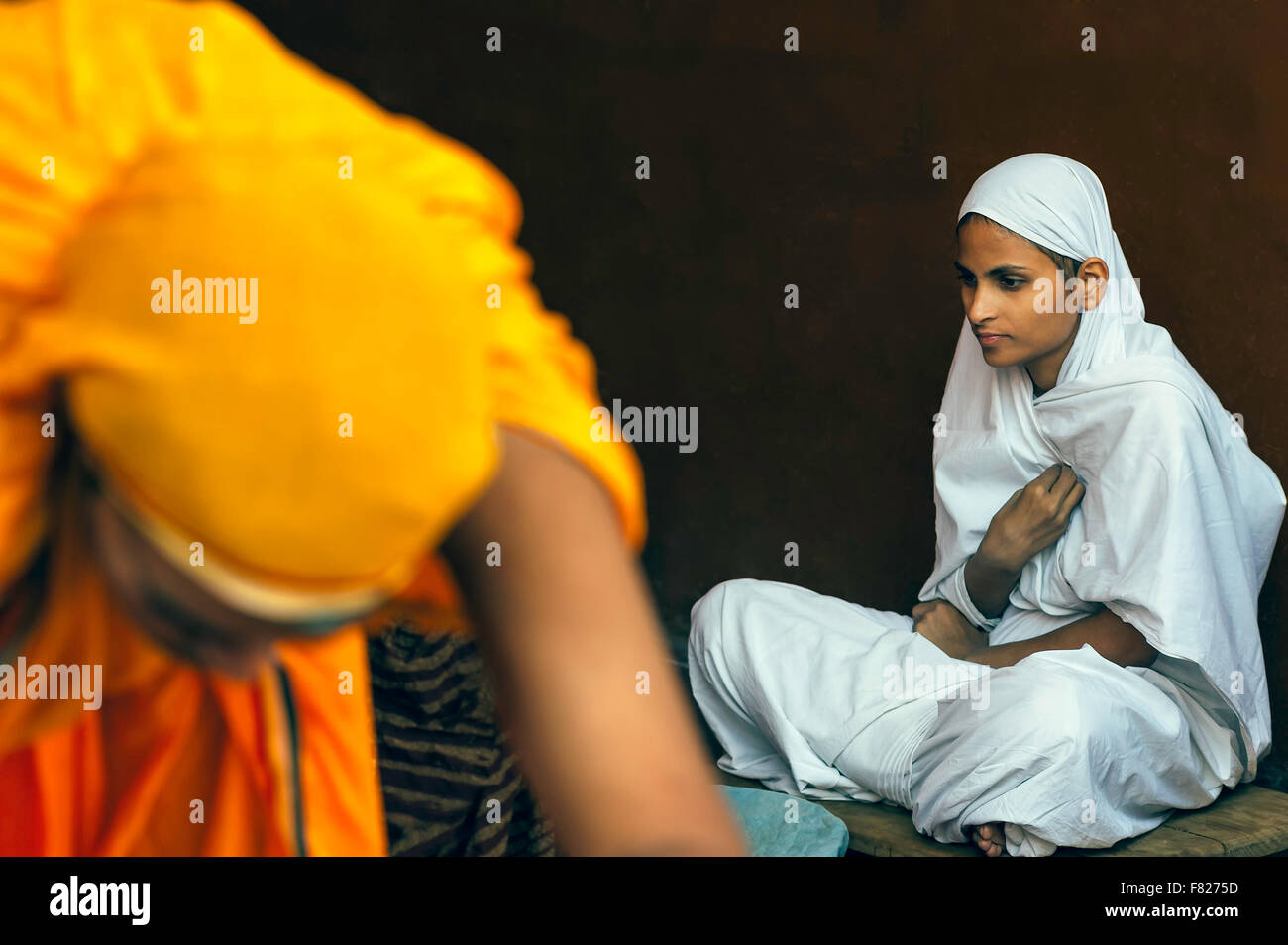 A Digambara Jain nun waits patiently for food during Chaturmas festival ...
