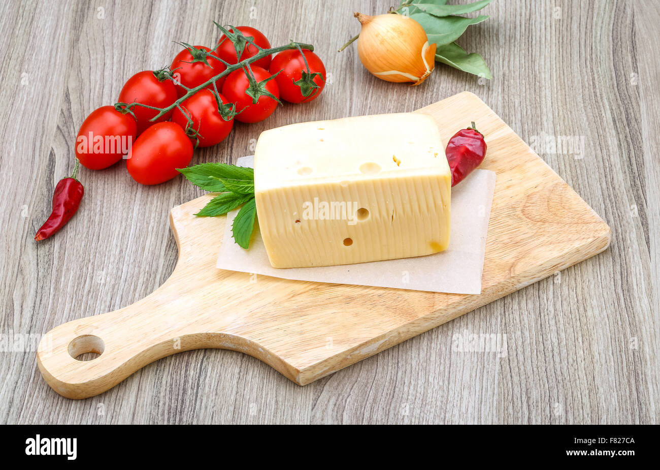 Yellow cheese brick with mint leaves on the wood background Stock Photo ...