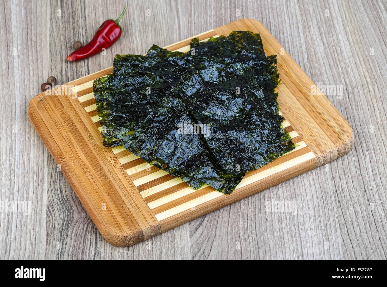 Korean traditional snack - Nori seaweed sheets on the wood background ...