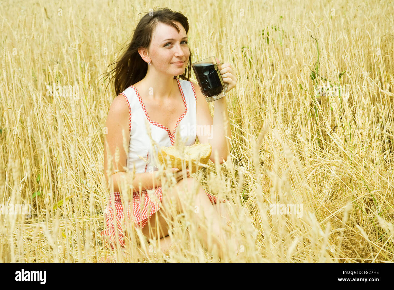 Girl with kvass at cereals field in summer Stock Photo - Alamy