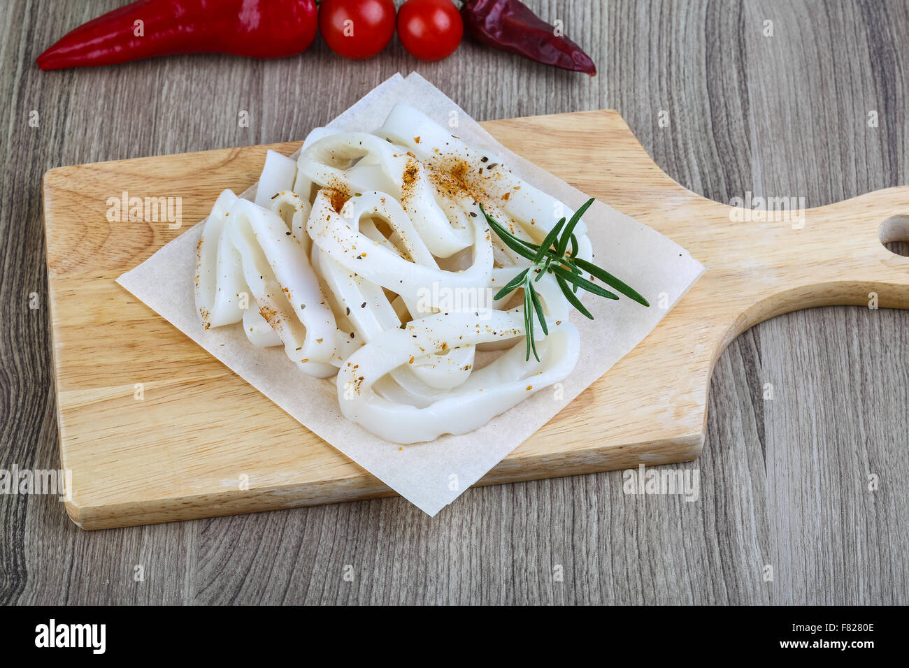 Raw squid rings with rosemary and spices - ready for cooking Stock ...
