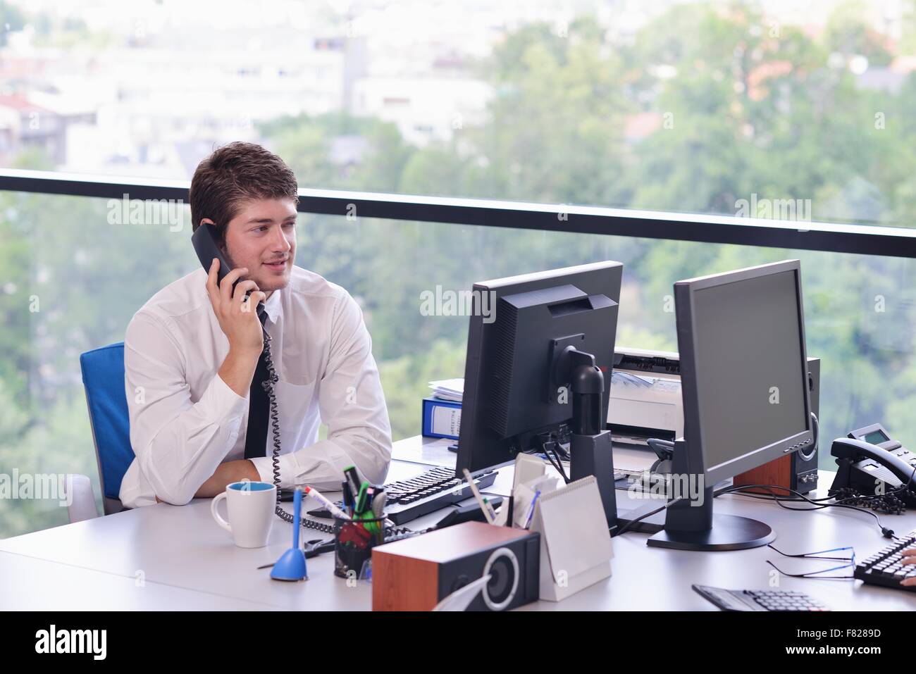 happy young business man work in modern office on computer Stock Photo ...