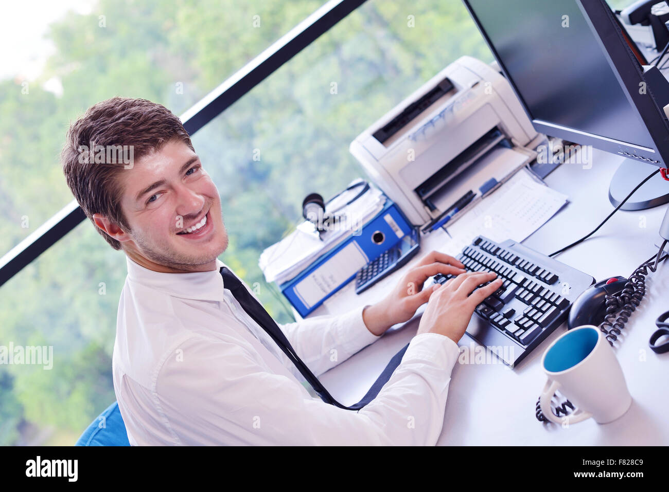 happy young business man work in modern office on computer Stock Photo ...