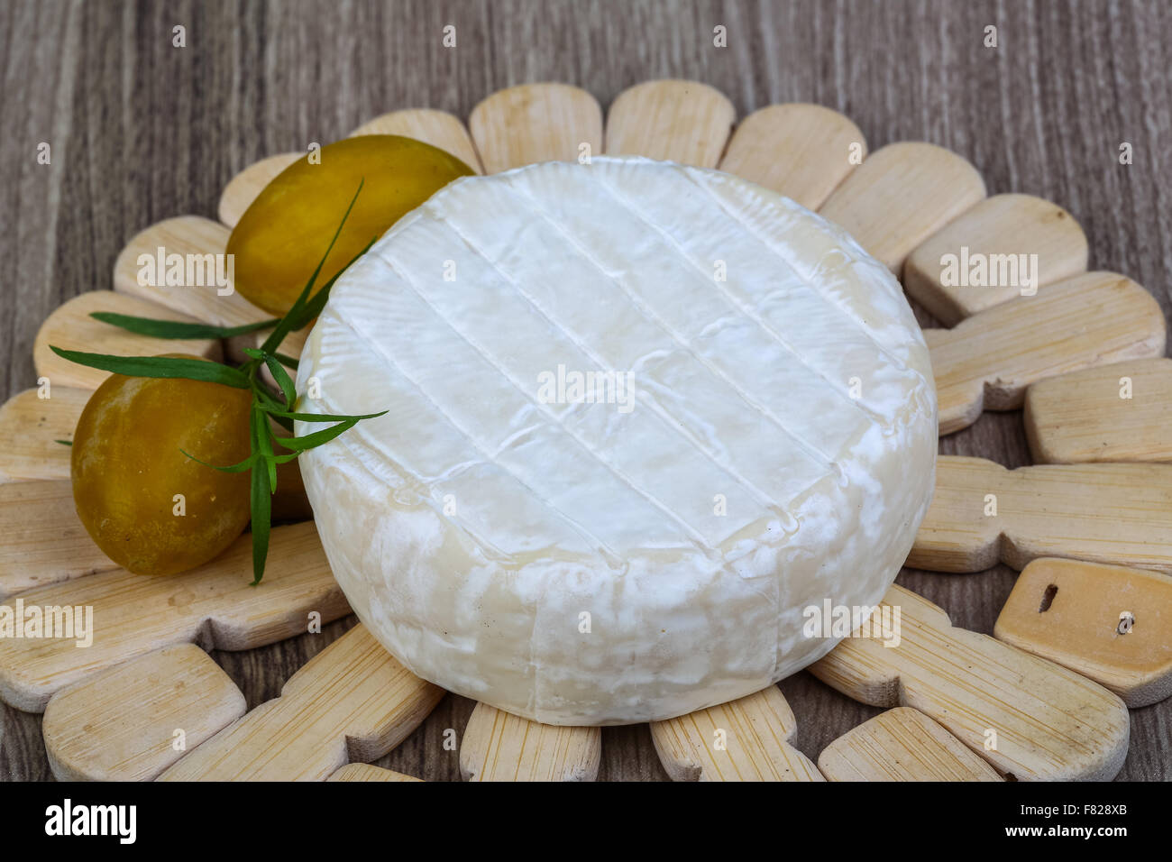 Round Brie cheese with yellow plums and estragon Stock Photo - Alamy