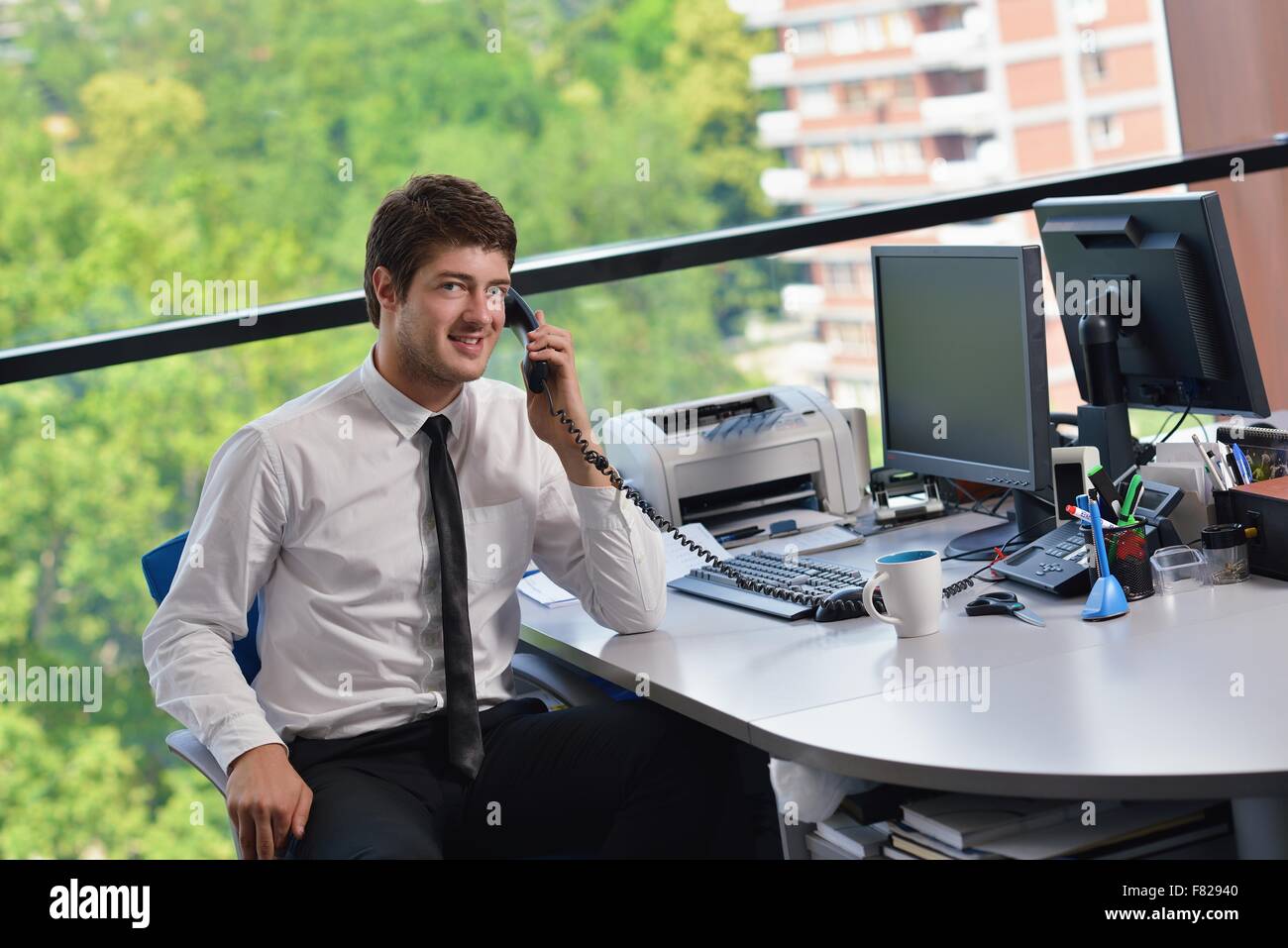 happy young business man work in modern office on computer Stock Photo ...
