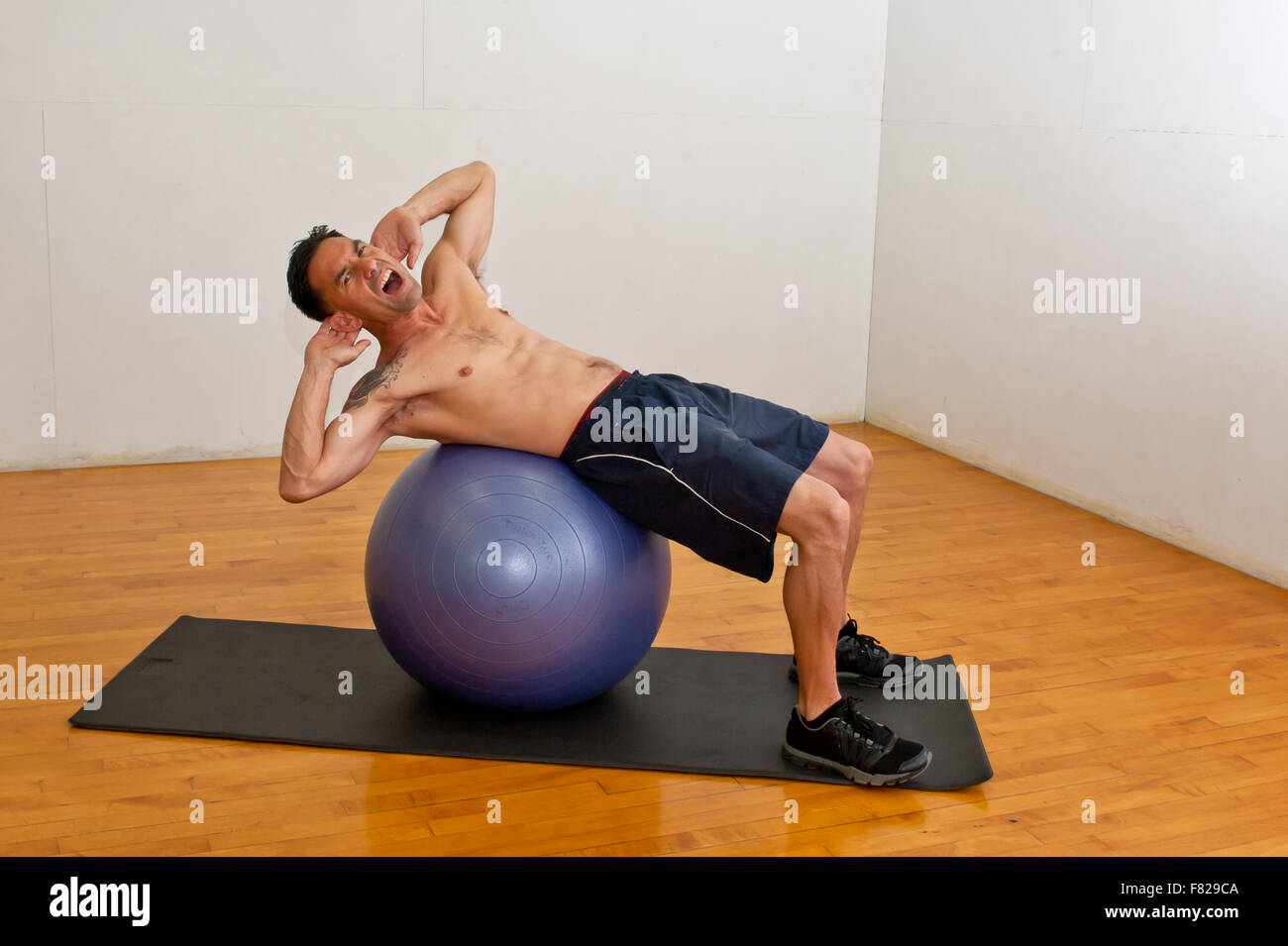 Middle age man showing stability oblique crunch Stock Photo - Alamy