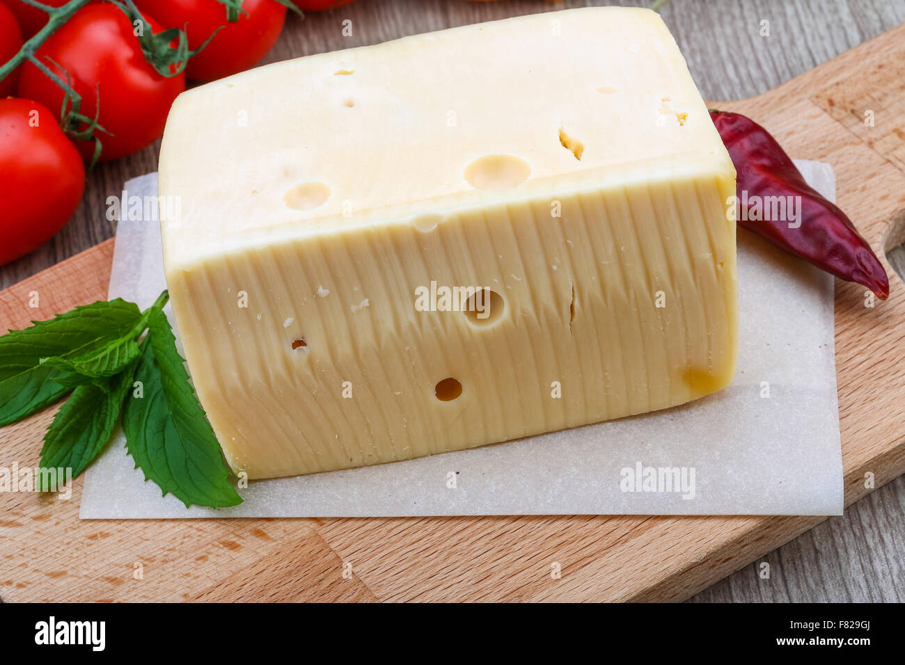 Yellow cheese brick with mint leaves on the wood background Stock Photo ...