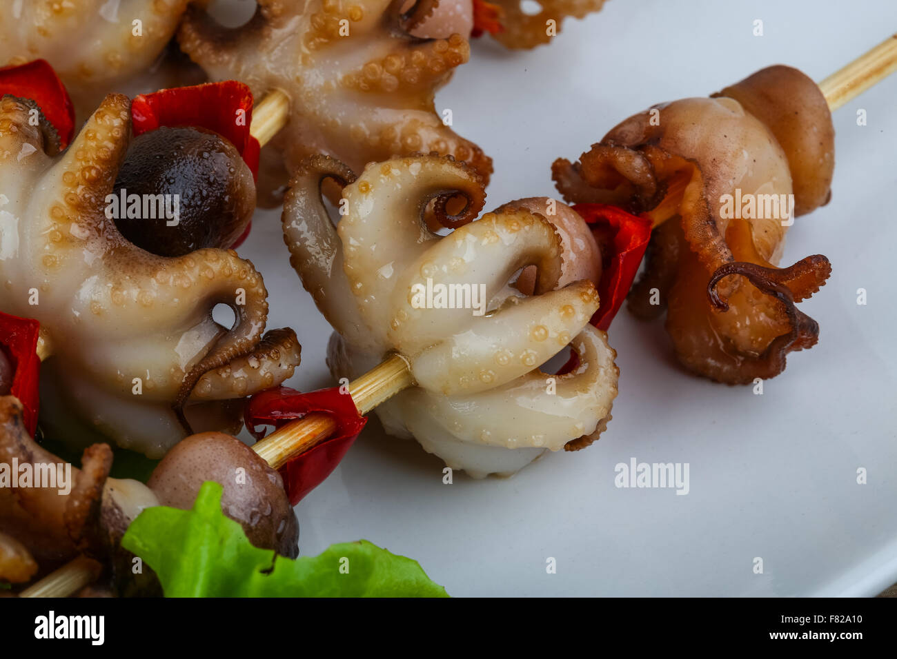Grilled octopus skewers with red pepper and onion Stock Photo - Alamy