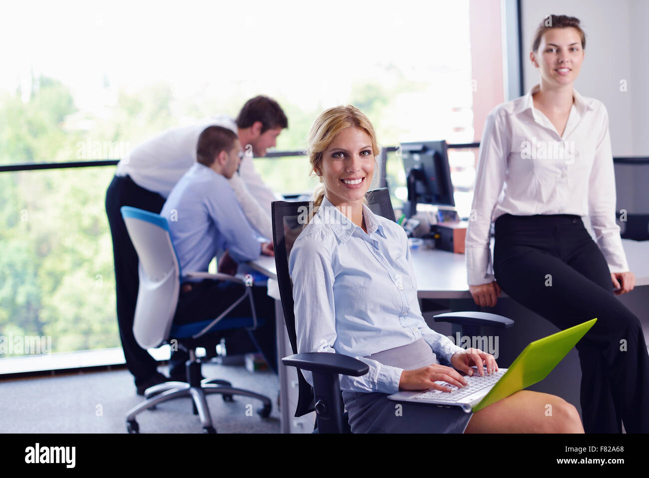 business woman with her staff, people group in background at modern ...