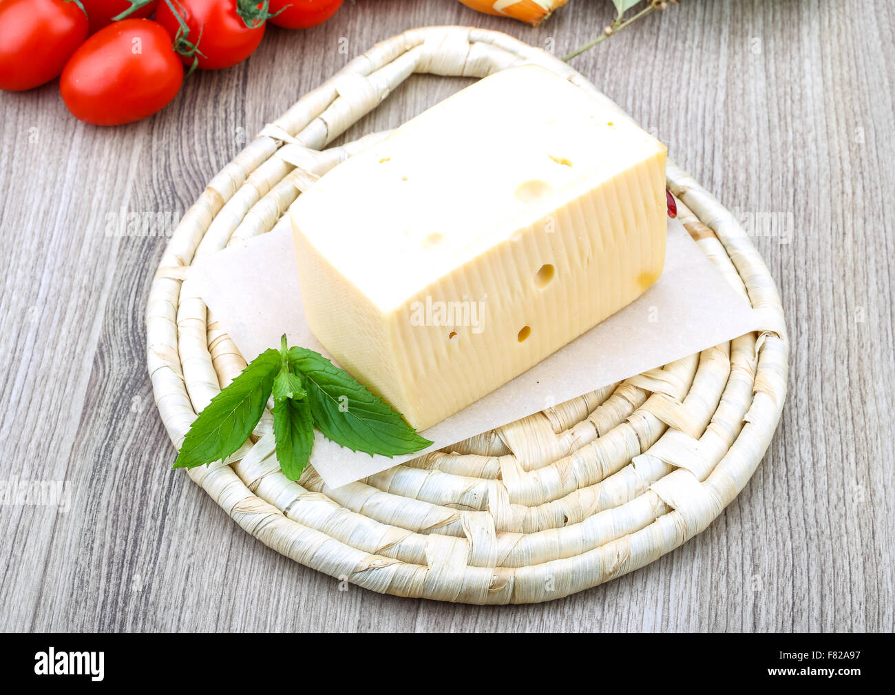 Yellow cheese brick with mint leaves on the wood background Stock Photo ...