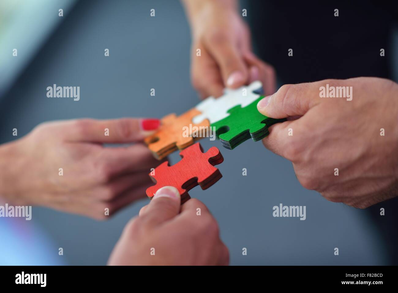 Group of business people assembling jigsaw puzzle and represent team ...