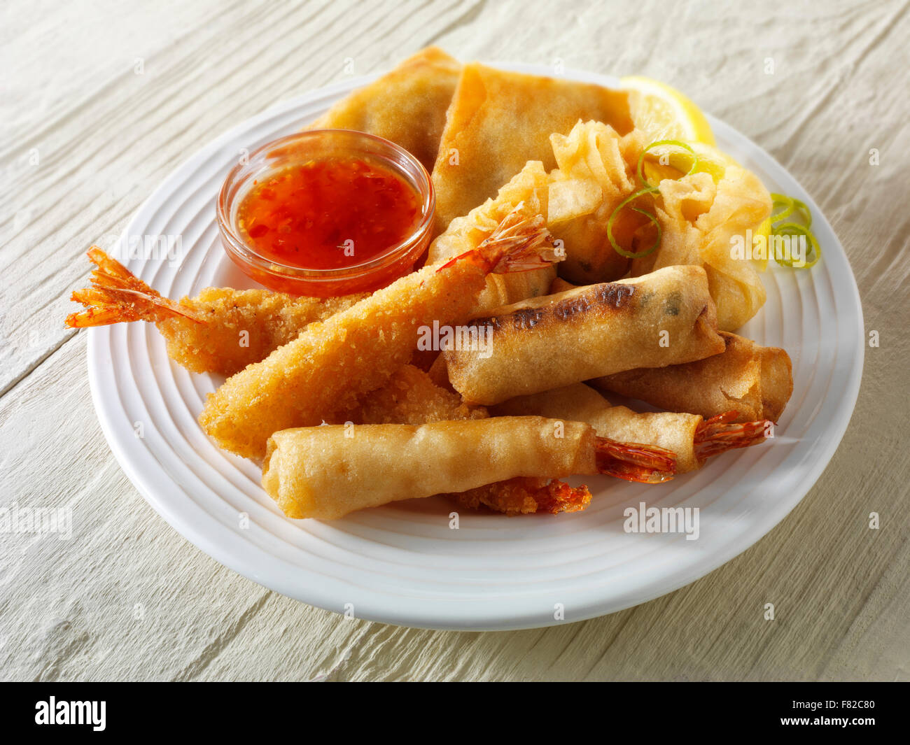 Cooked mixed Chinese starters - Dim sum, breaded prawns, spring rolls ...