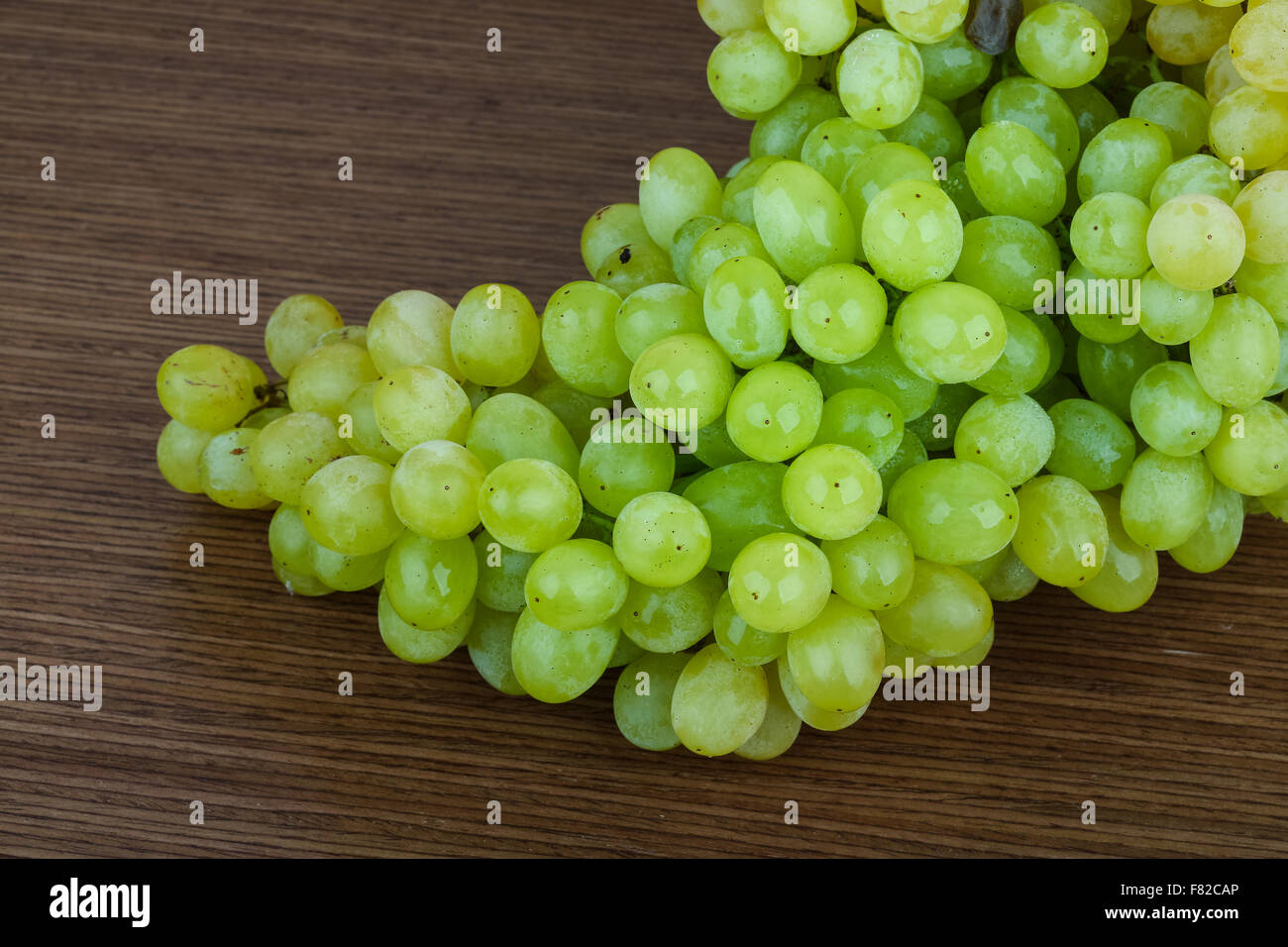 Ripe Green grapes on the wood background Stock Photo - Alamy