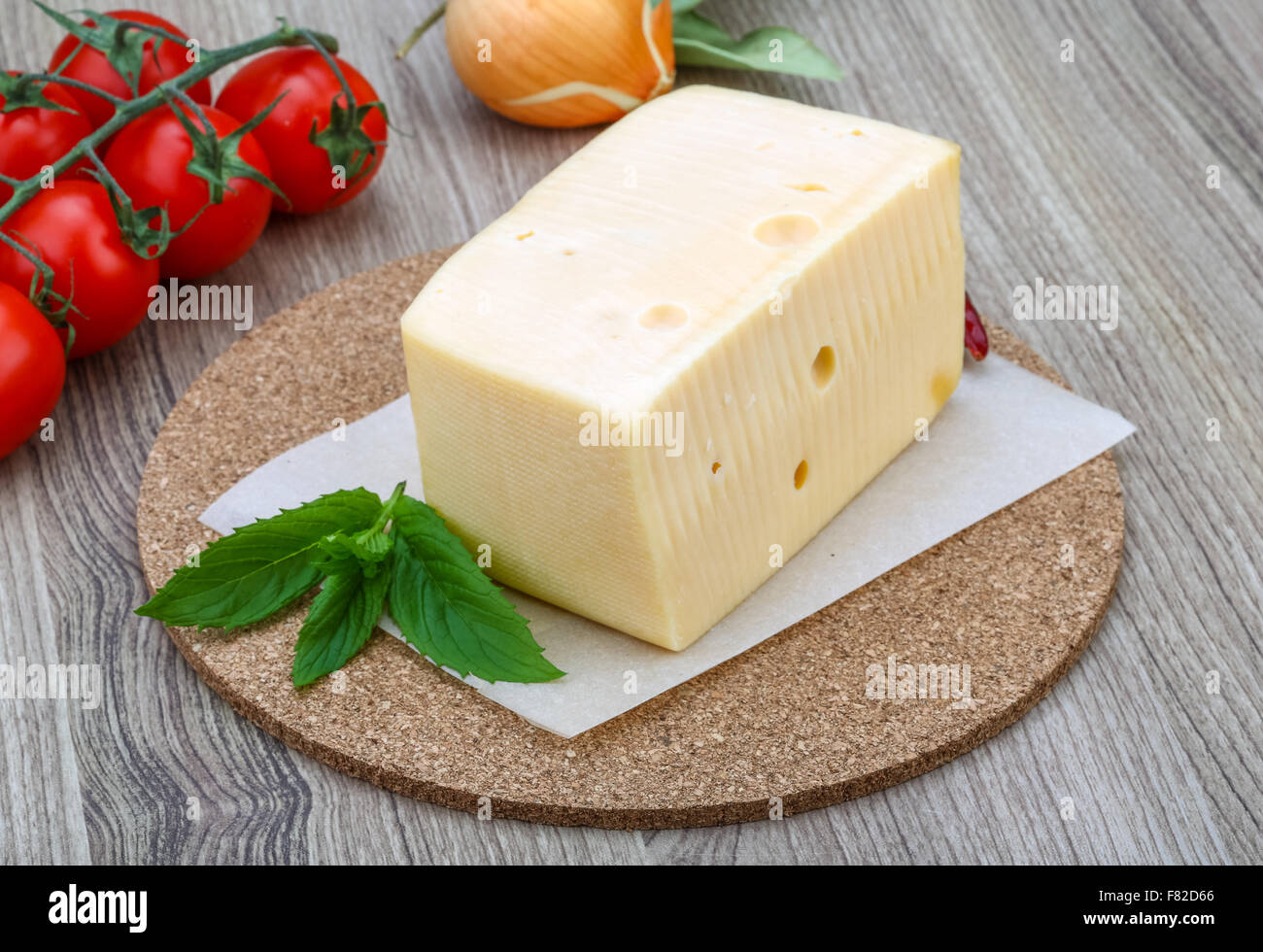 Yellow cheese brick with mint leaves on the wood background Stock Photo ...