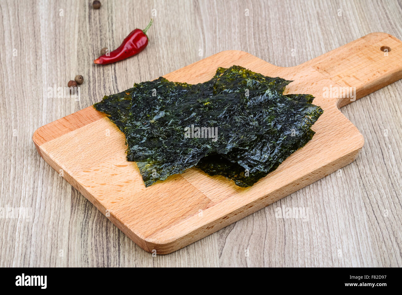 Korean traditional snack - Nori seaweed sheets on the wood background ...