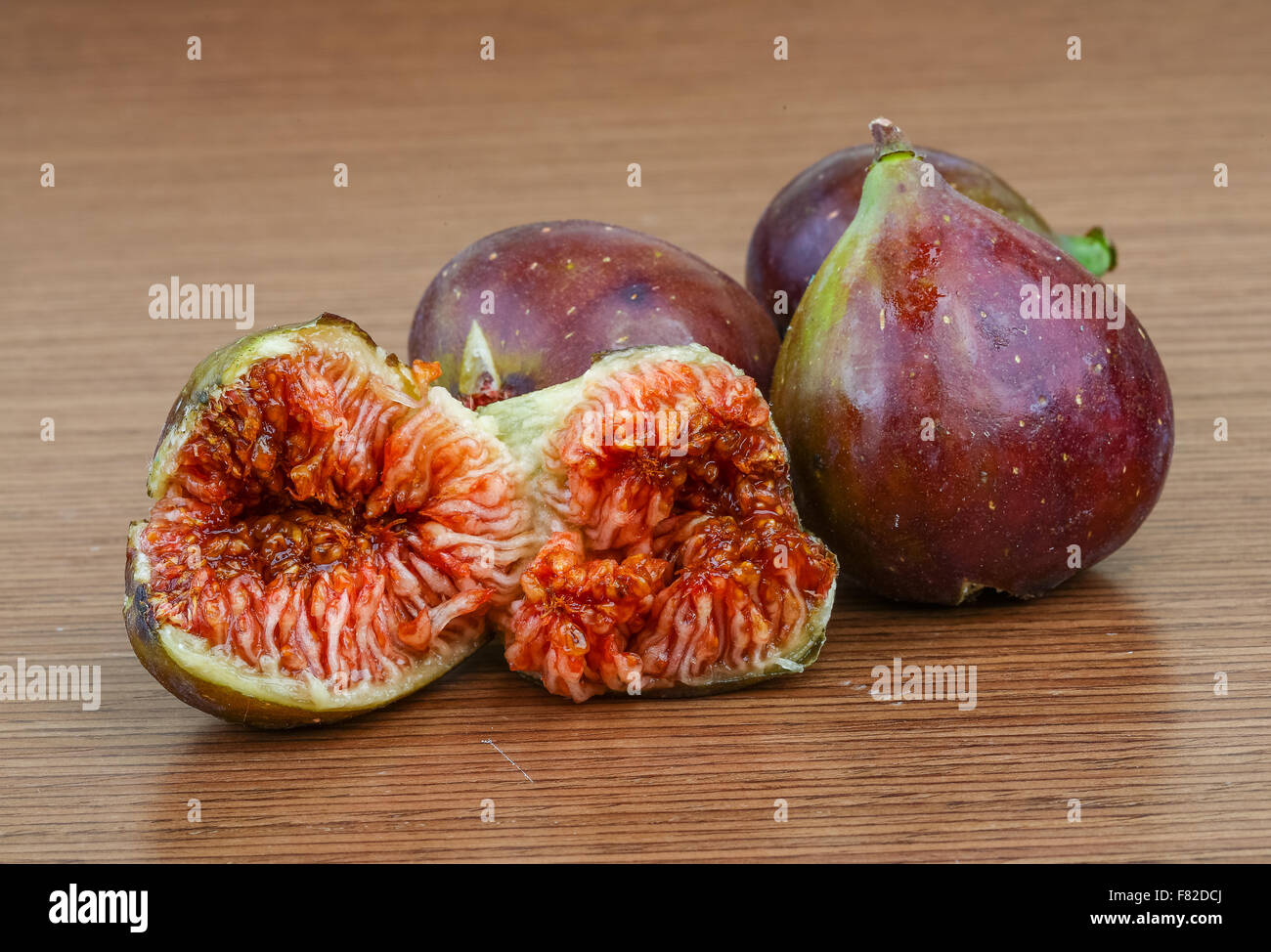 Fresh ripe Figs on the wood background Stock Photo - Alamy